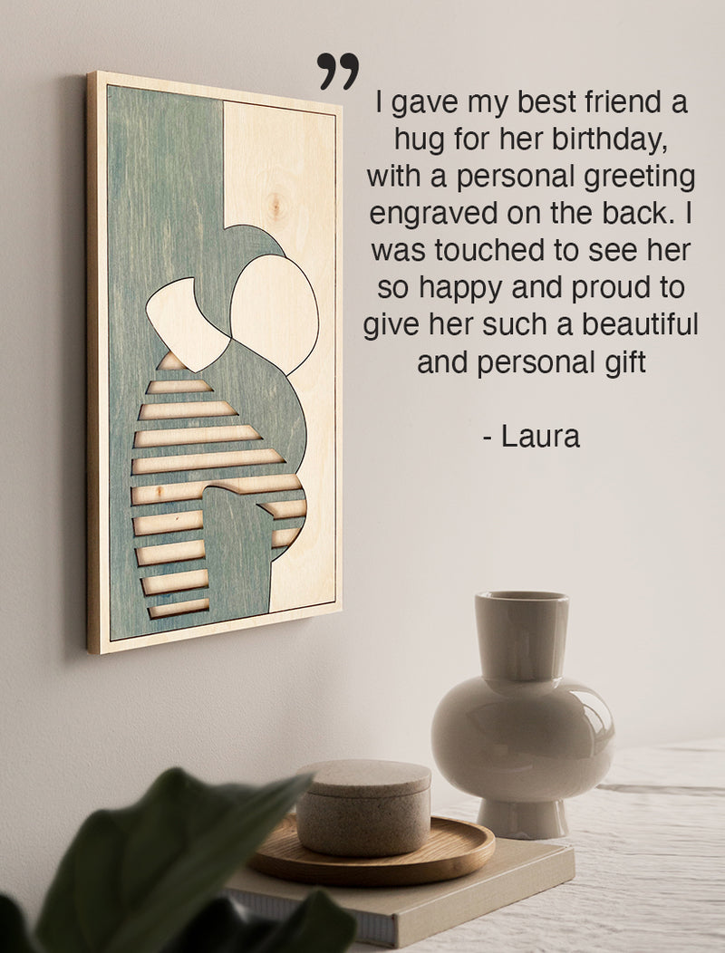 Graphic artwork of a hug cut in wood by KOLEKTO studio